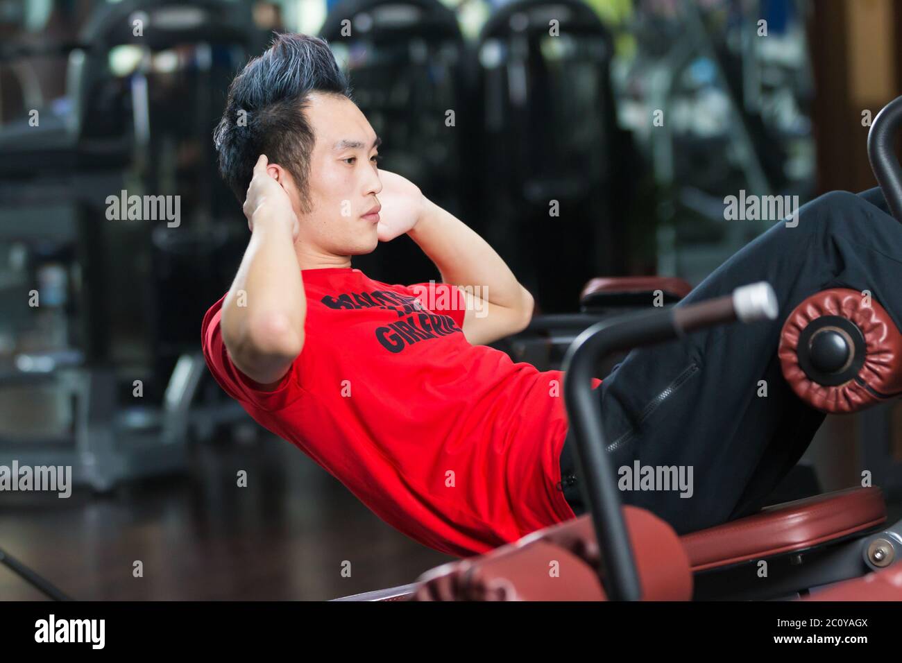 young asian man working out in modern gym Stock Photo - Alamy
