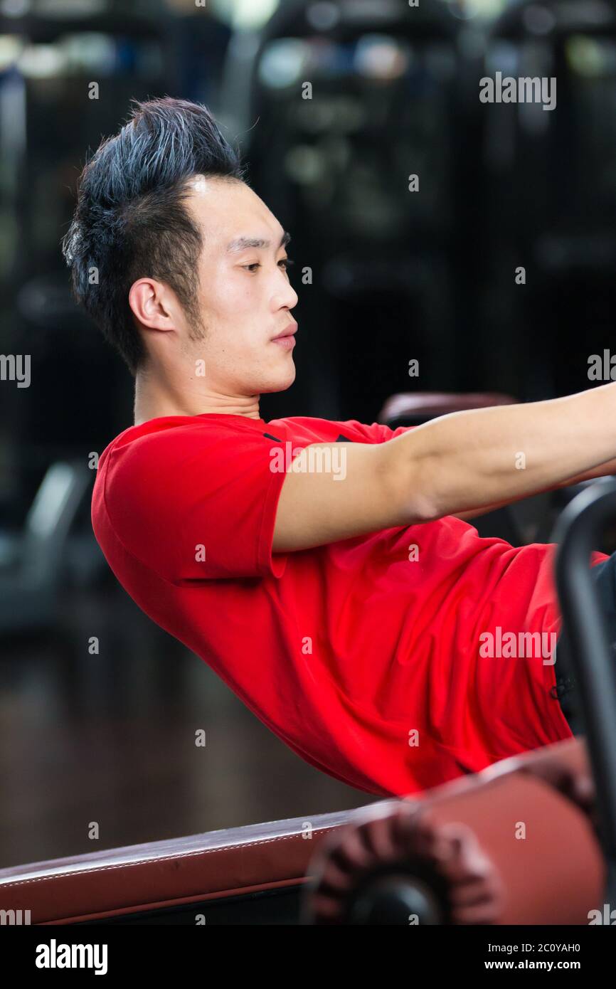 young asian man working out in modern gym Stock Photo - Alamy