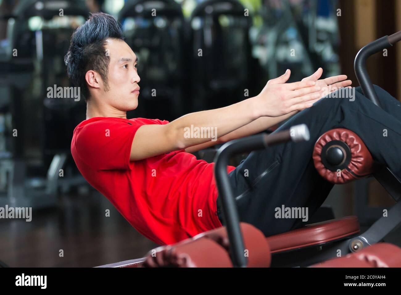 young asian man working out in modern gym Stock Photo - Alamy