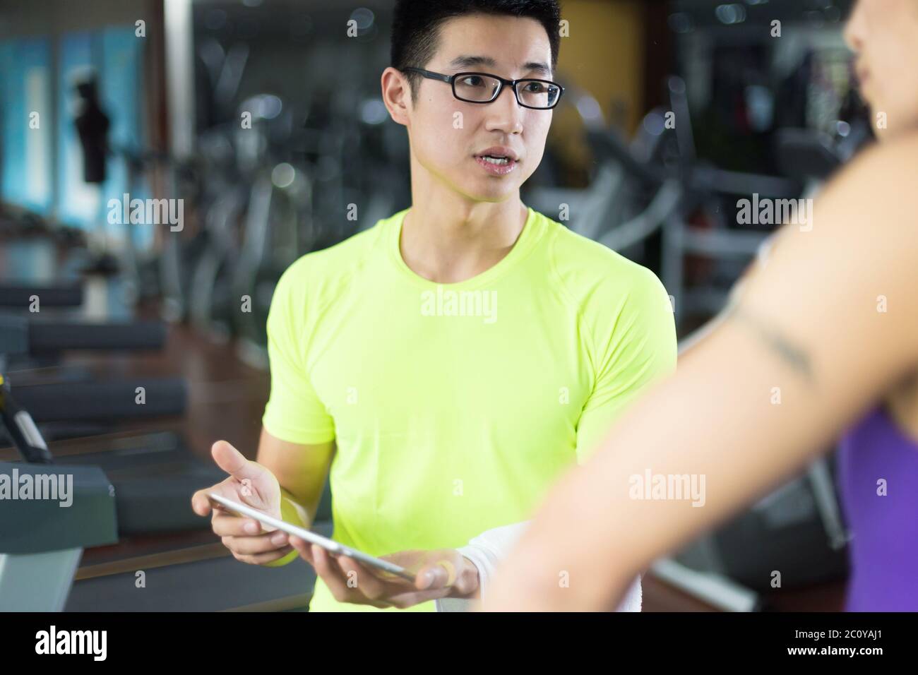 young asian people talking by tablet in modern gym Stock Photo - Alamy