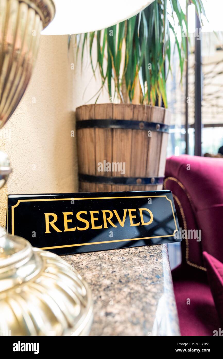 A tag of reservation placed on table. Reserved logo in a restaurant or ...