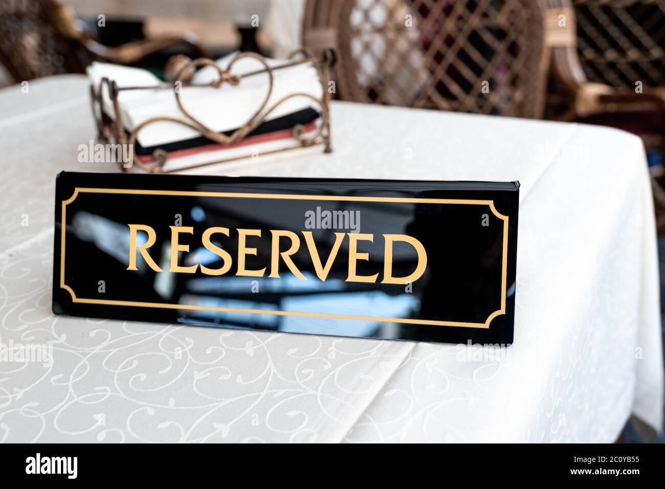 A tag of reservation placed on table. Reserved logo in a restaurant or ...