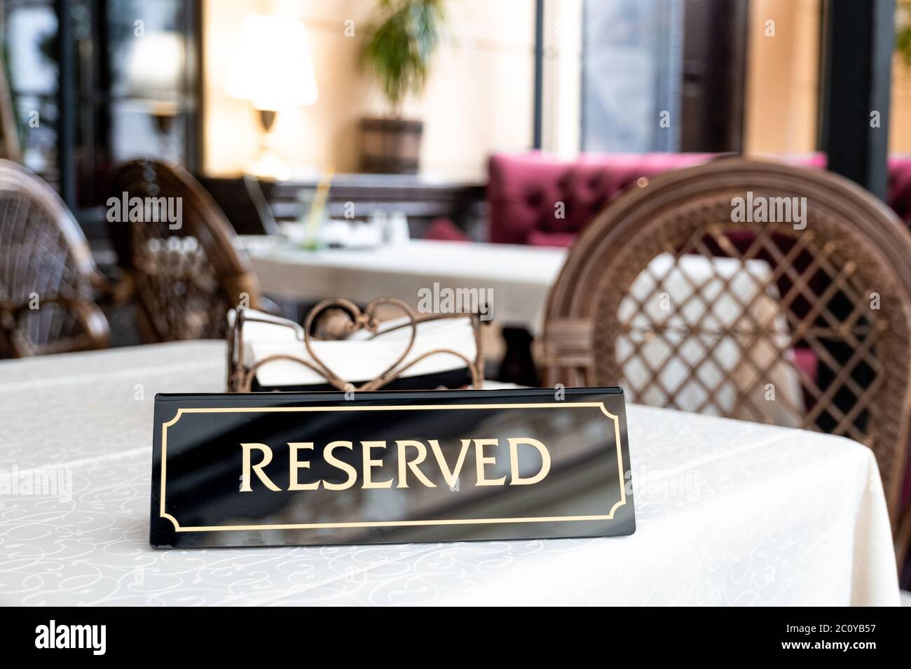 A tag of reservation placed on table. Reserved logo in a restaurant or ...