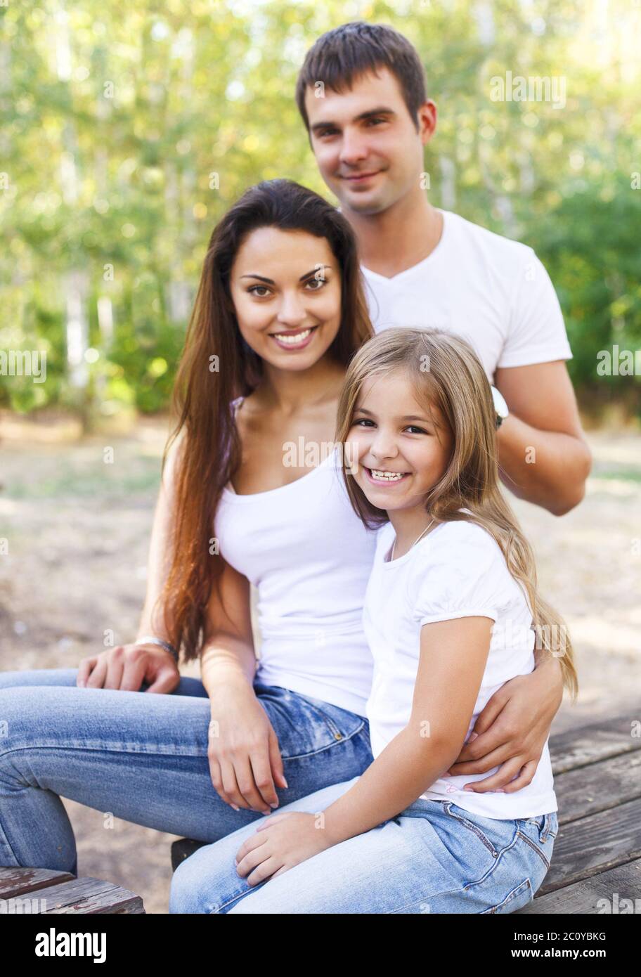 Happy mother, father and their daughter in the park Stock Photo - Alamy