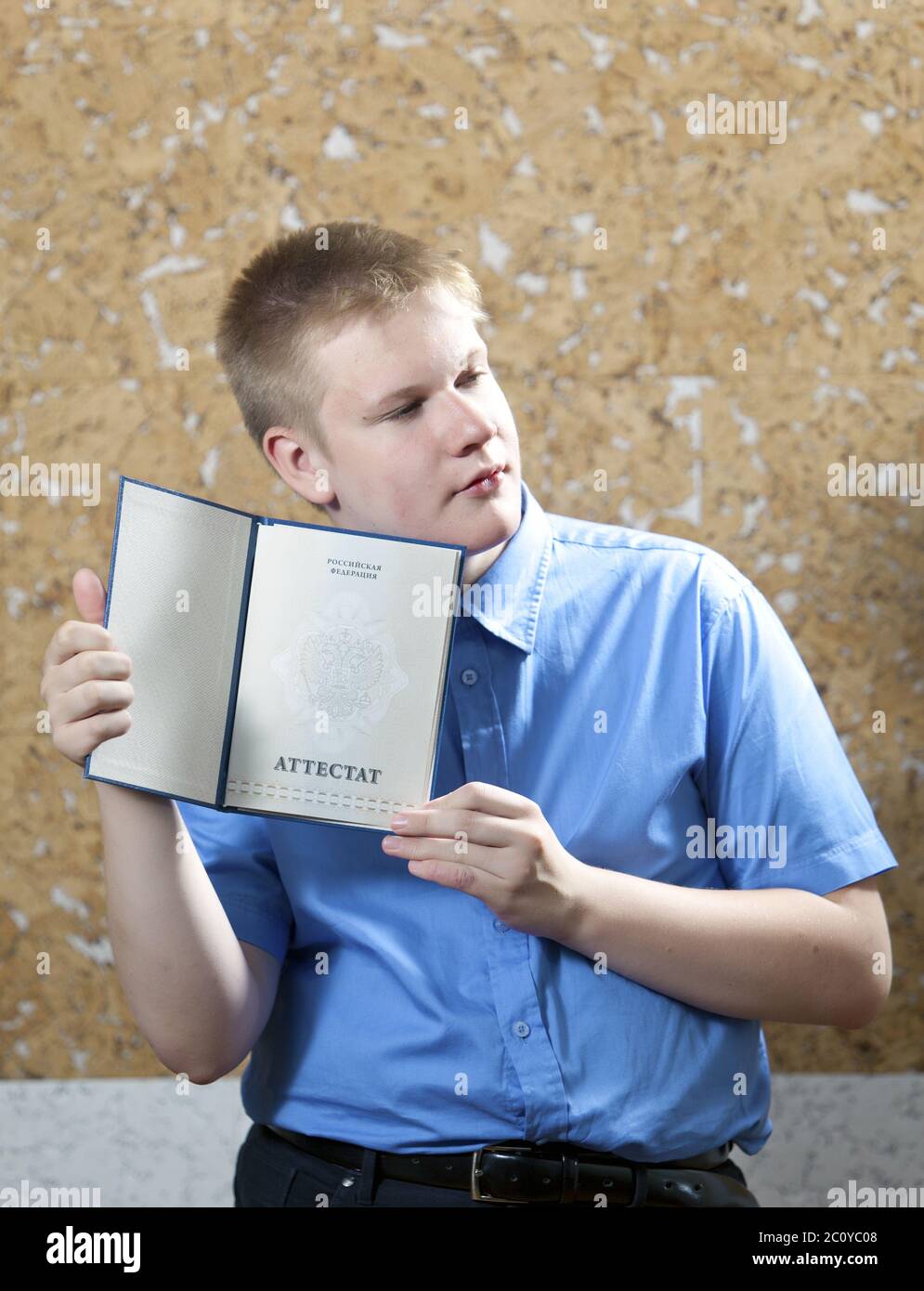 schoolboy with the certificate about completion of education at school ...
