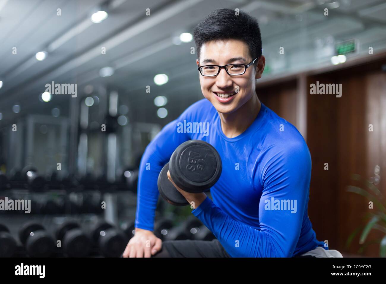 young asian man working out in modern gym Stock Photo - Alamy