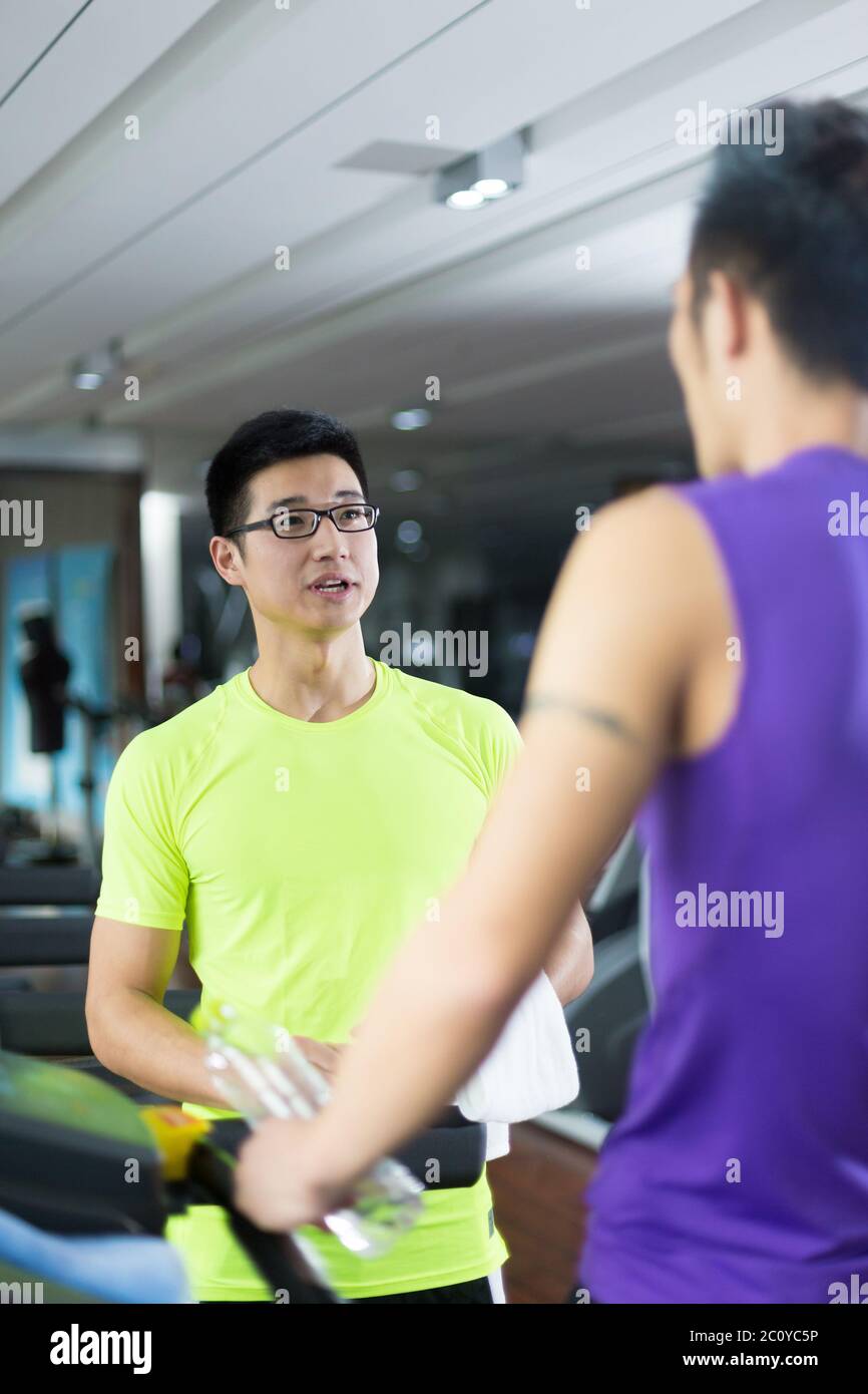 young asian people talking in modern gym Stock Photo - Alamy