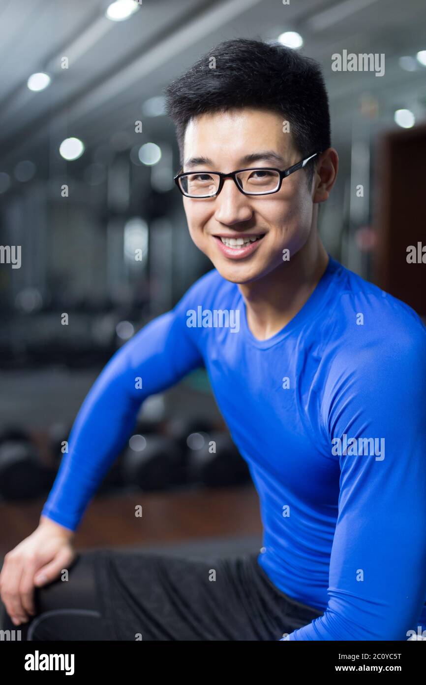 young asian man working out in modern gym Stock Photo - Alamy