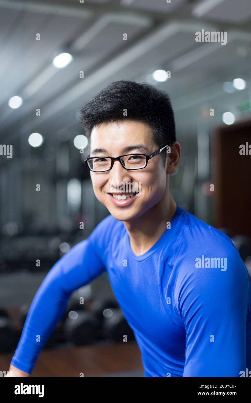 young asian man working out in modern gym Stock Photo - Alamy