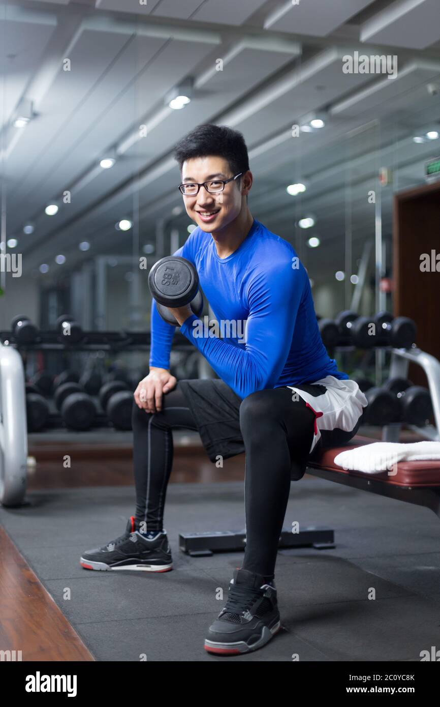 young asian man working out in modern gym Stock Photo - Alamy