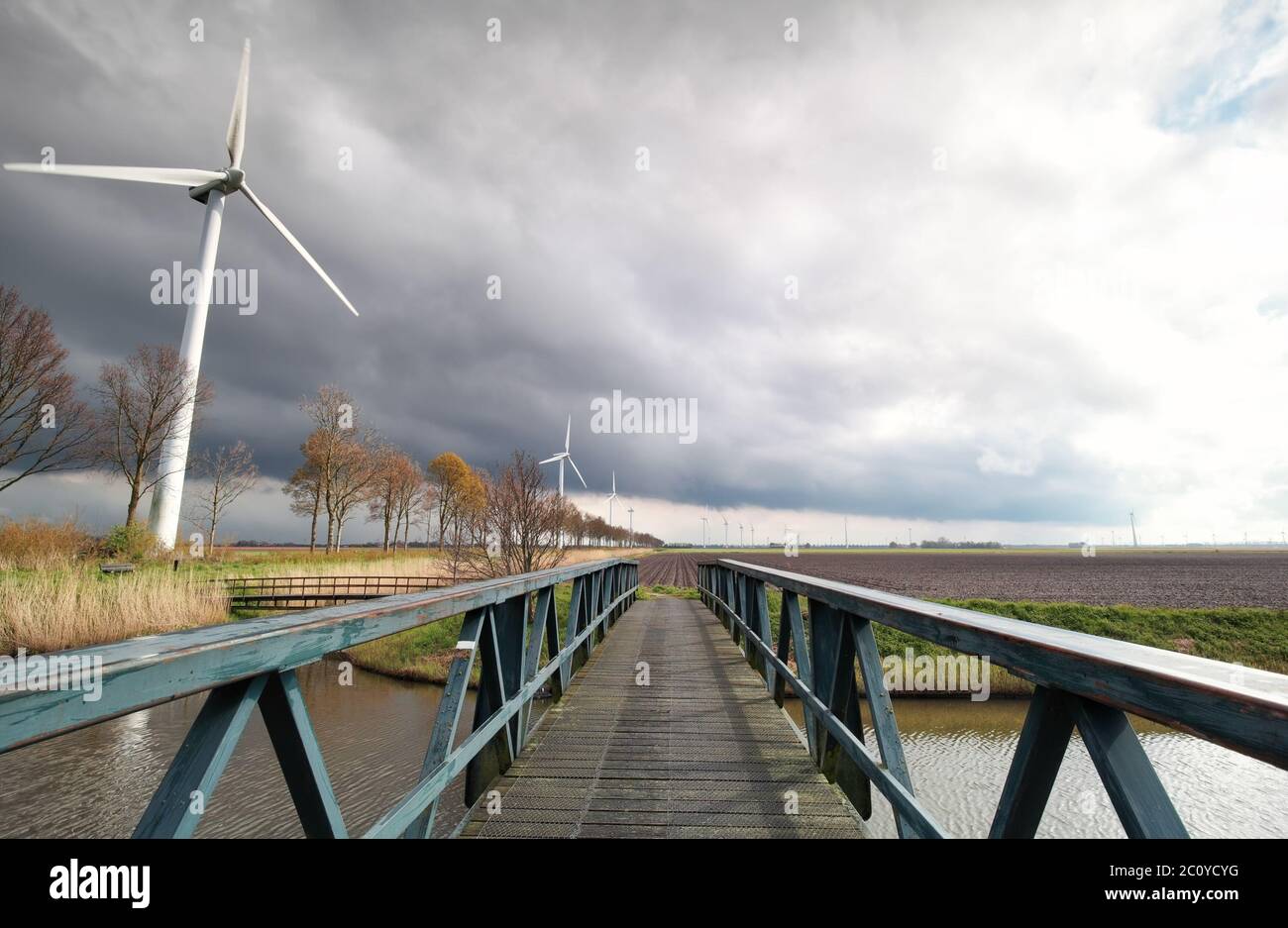 wind turbines on Dutch farmland in sunshine Stock Photo - Alamy