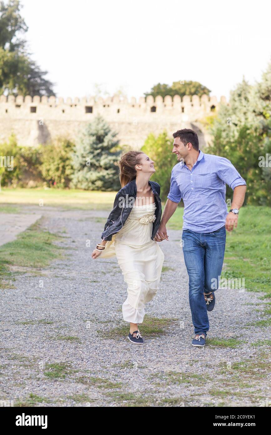 Beautiful happy smiling running couple Stock Photo - Alamy