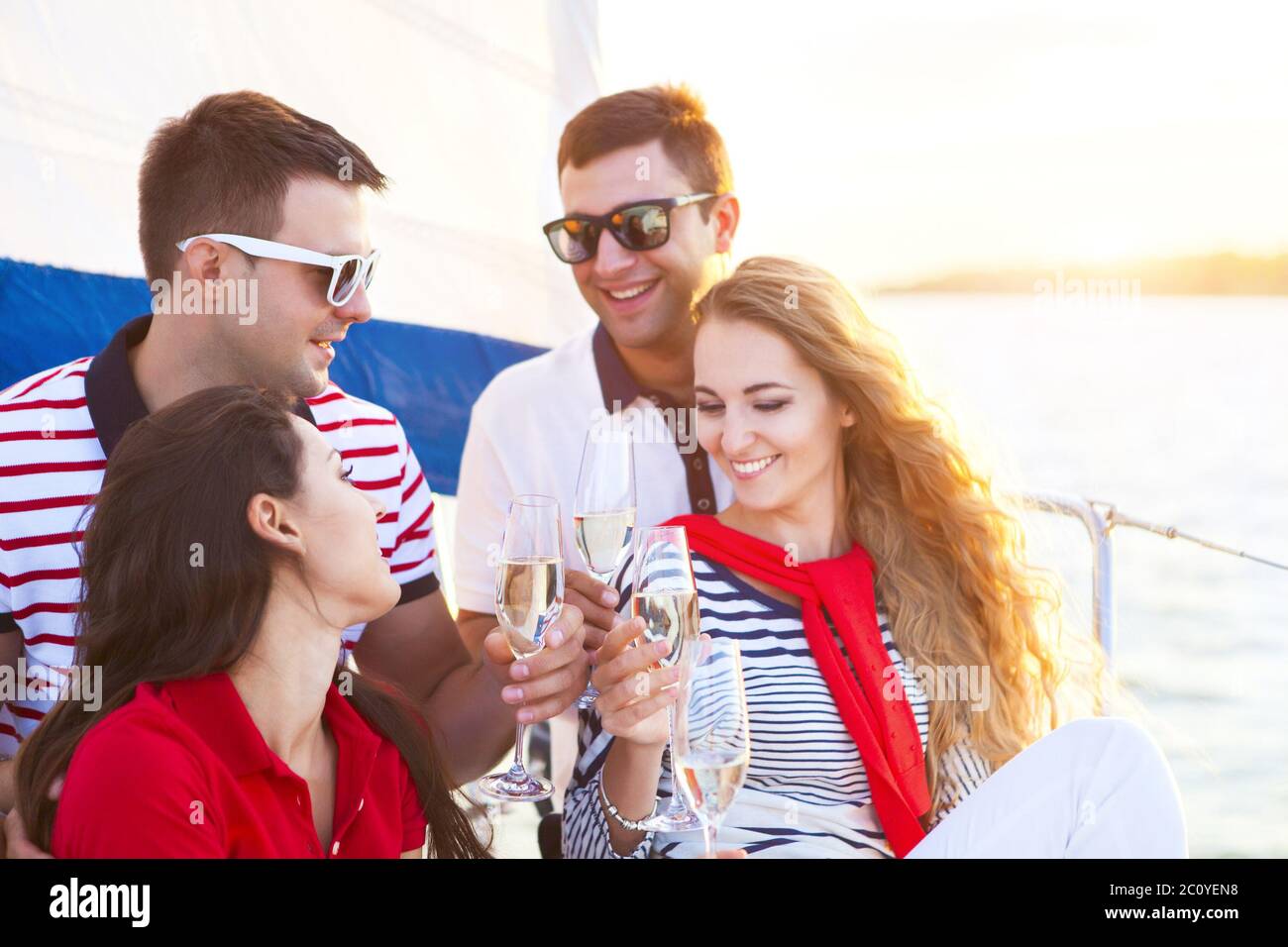 Smiling friends sitting on yacht deck Stock Photo - Alamy