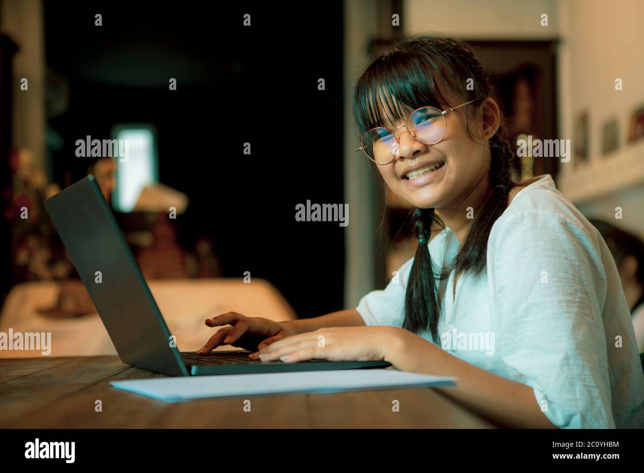 asian teenager typing on computer laptop keypad toothy smiling face to ...