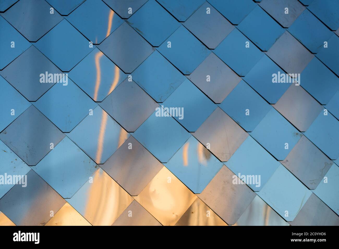 old, dirty aluminum metal wall facade panel with rhombus, similar to ...