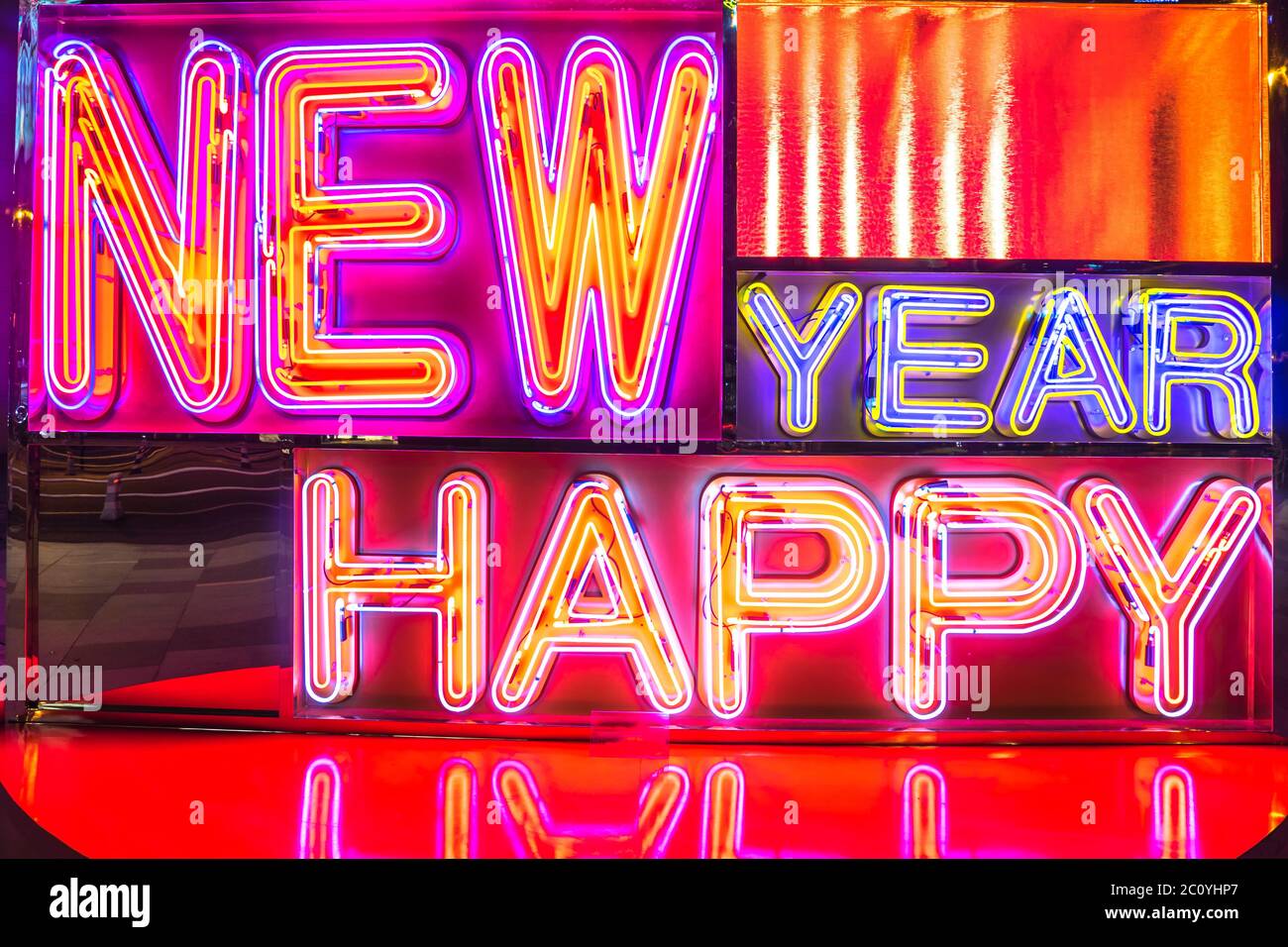 happy new year by neon light Stock Photo - Alamy