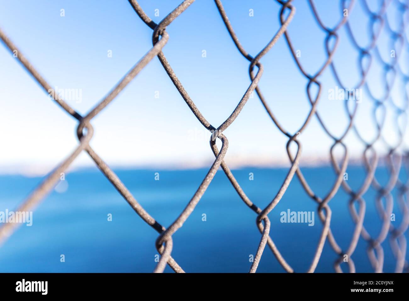 steel net with landscape of sea in blue sky Stock Photo - Alamy