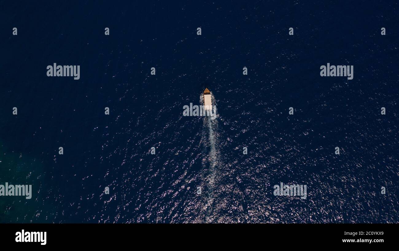 Top down view of a single fishing boat in the deep blue sea Stock Photo ...