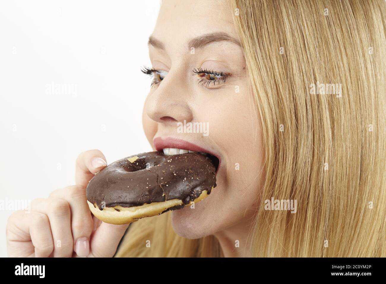 Gotcha - she's eating a donut Stock Photo - Alamy