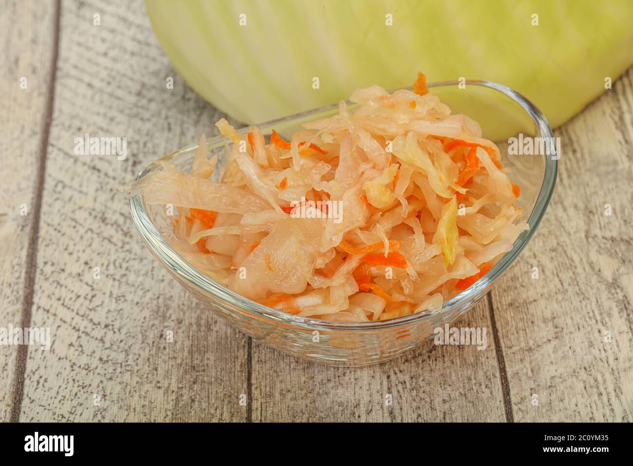 Pickled cabbage - sauerkraut in the bowl over wooden Stock Photo - Alamy