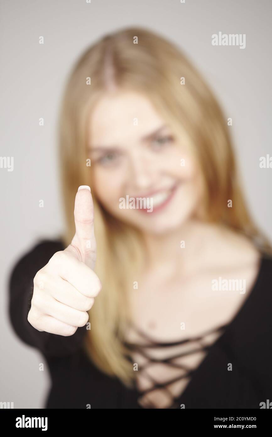 Thumbs up holding young hi-res stock photography and images - Alamy