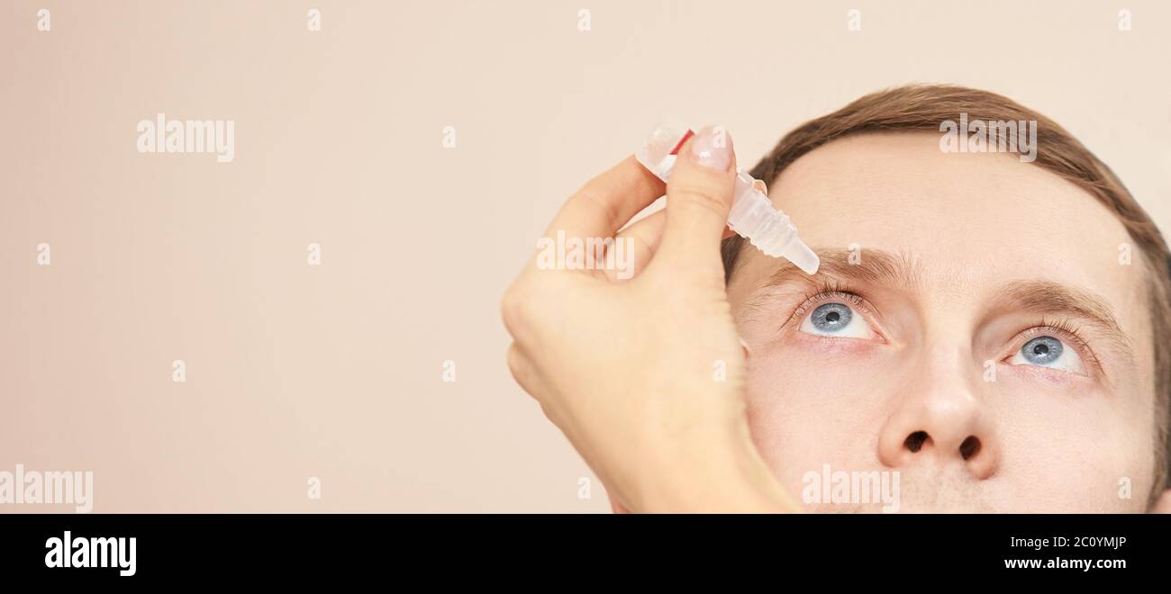 Doctor hold eye drops near patient face Stock Photo - Alamy