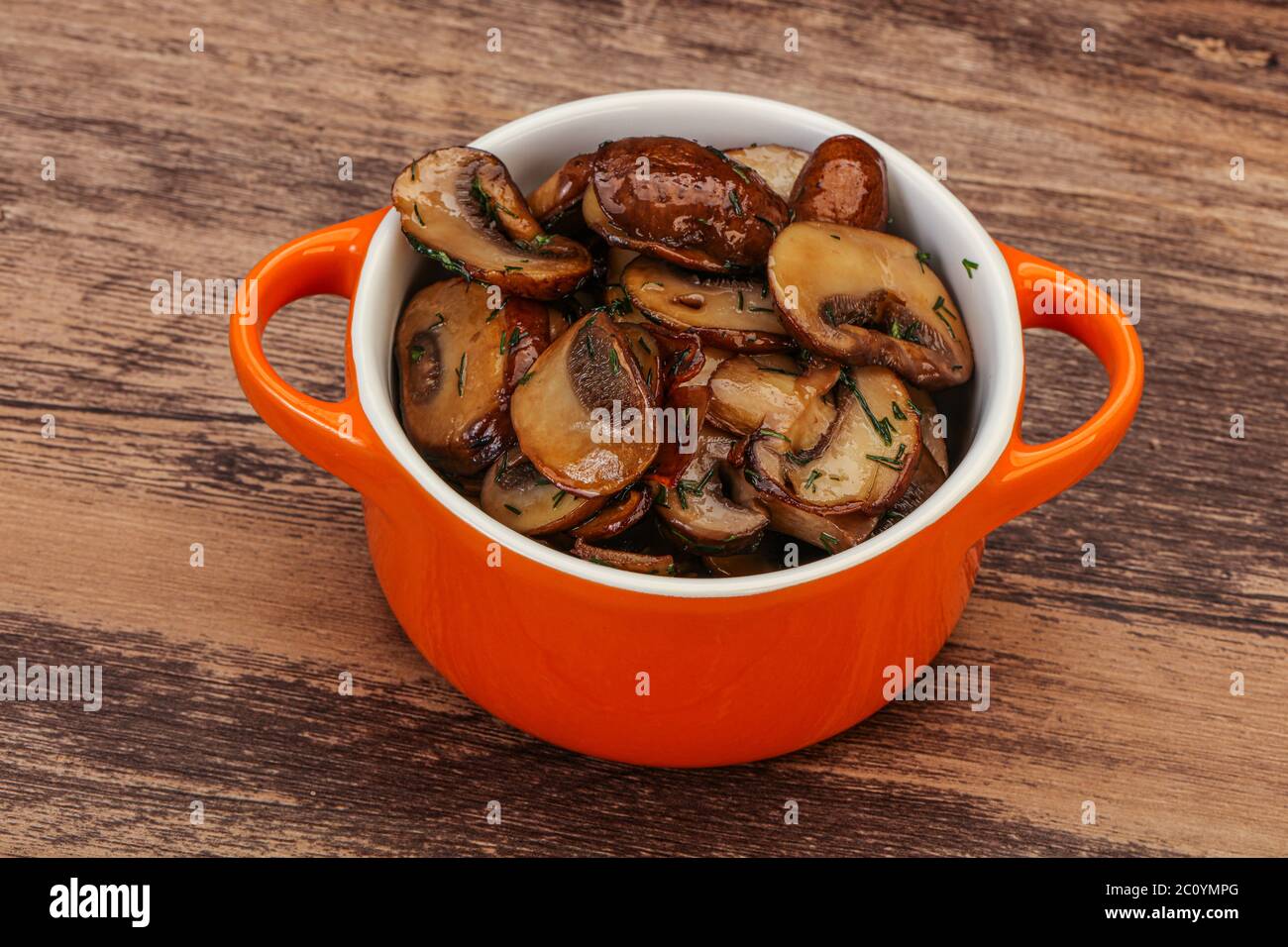 Roasted champignon with herbs and spices in the bowl Stock Photo - Alamy