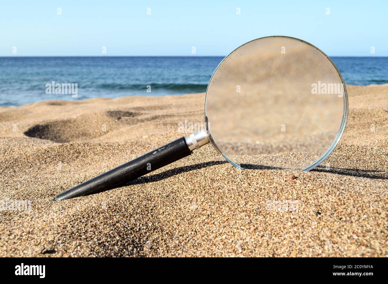 Magnify Glass on the Sand Beach Stock Photo - Alamy