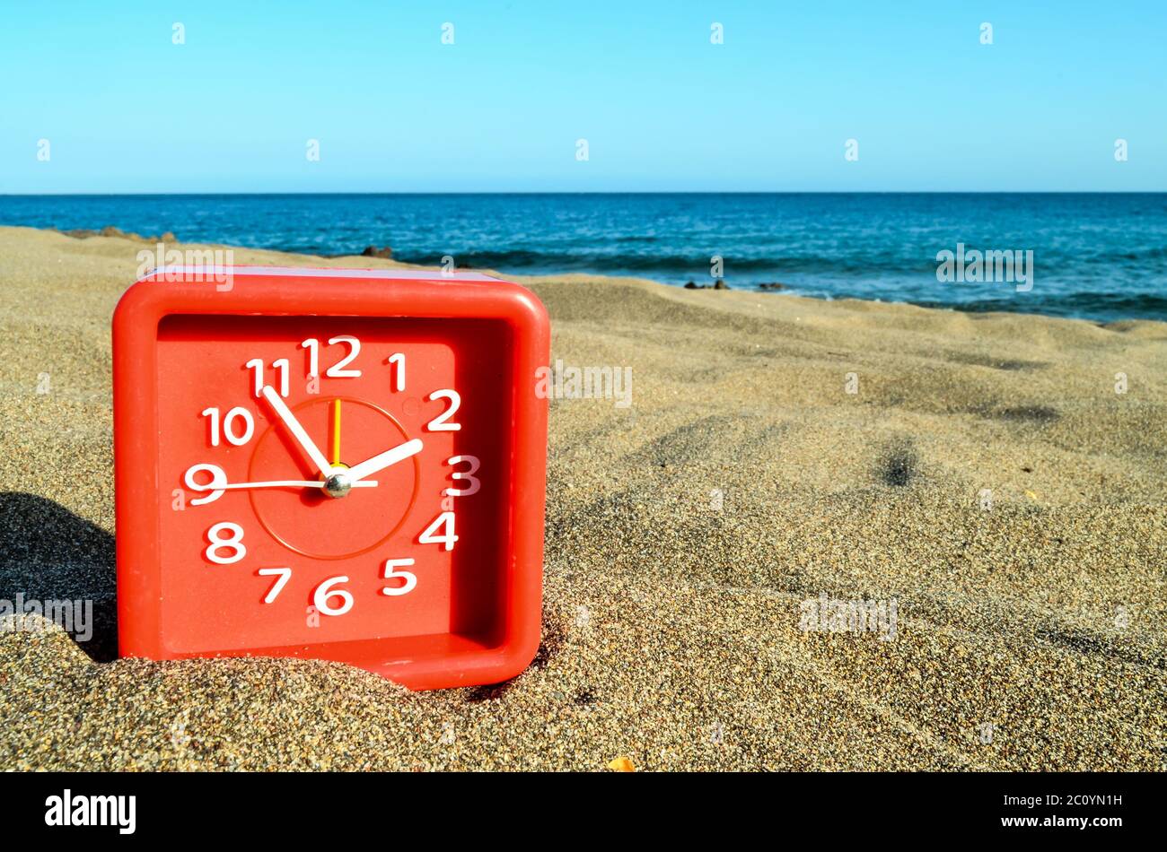 Clock on the Sand Beach Stock Photo - Alamy