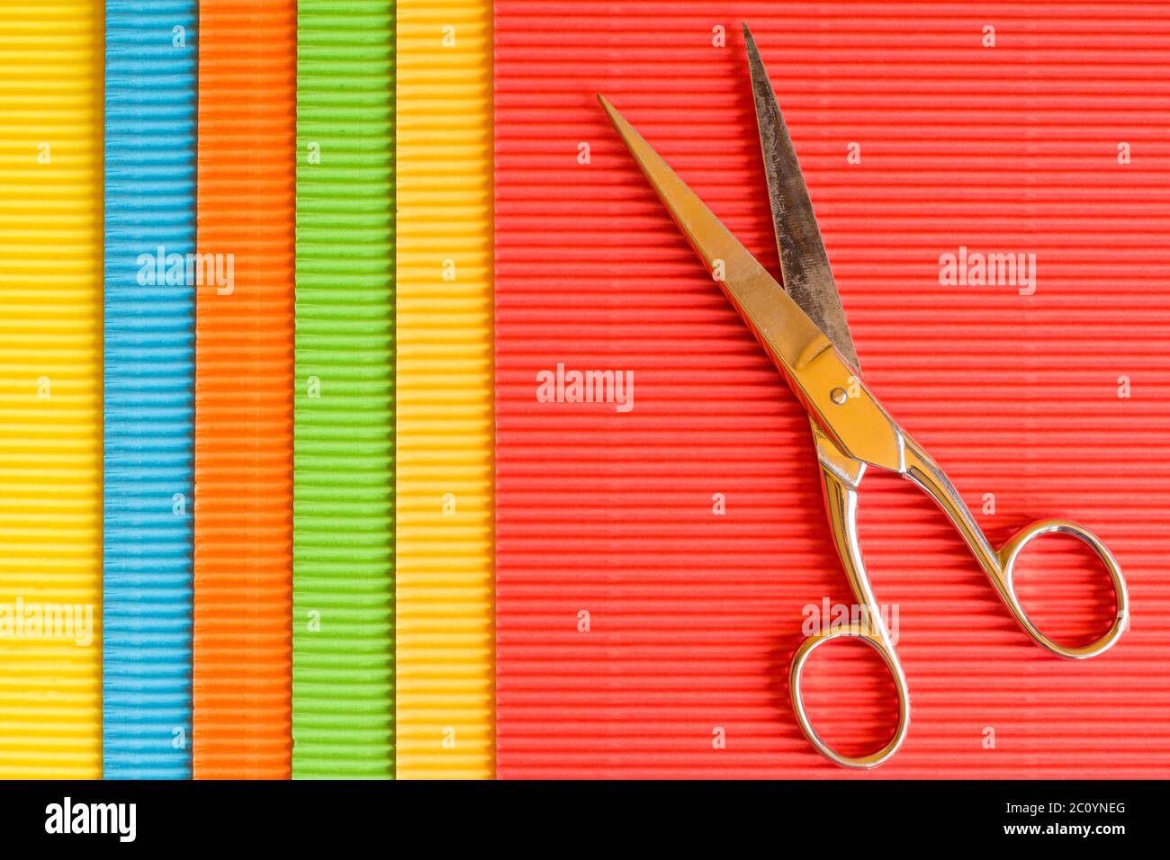 Scissors and colored corrugated paper Stock Photo - Alamy