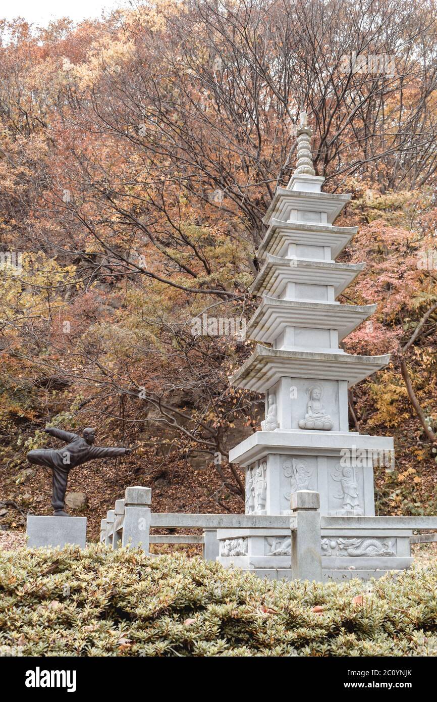 Korean religious pagoda with a statue of a martial arts fighting monk ...
