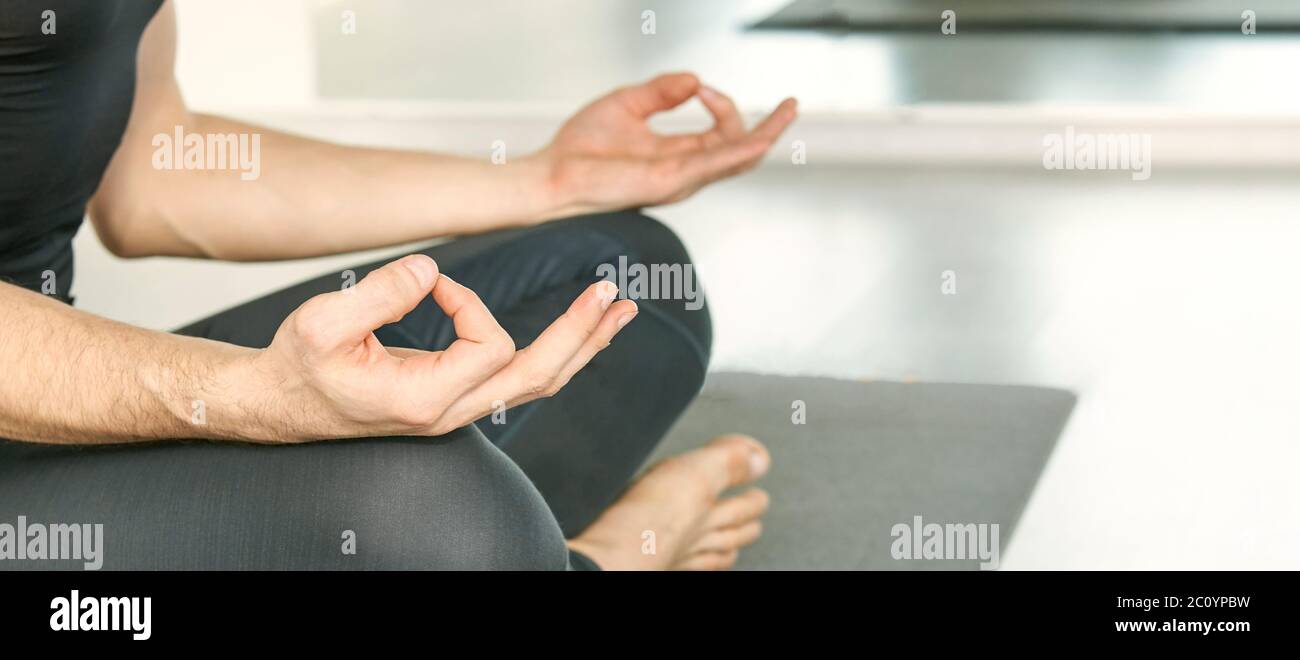 Yoga calm pose. Lotus asana at studio training. Man seated at mat ...