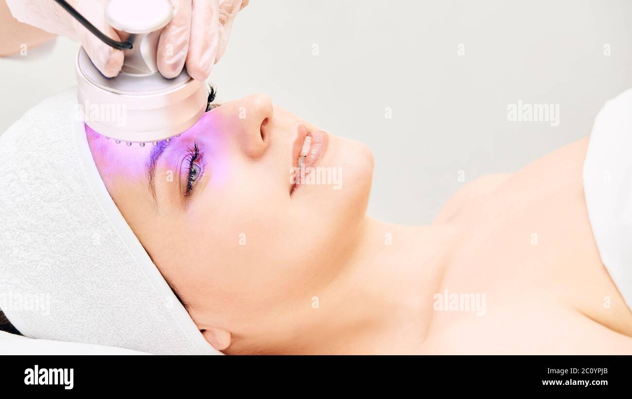 Light infrared therapy. Cosmetology head procedure. Beauty woman face ...