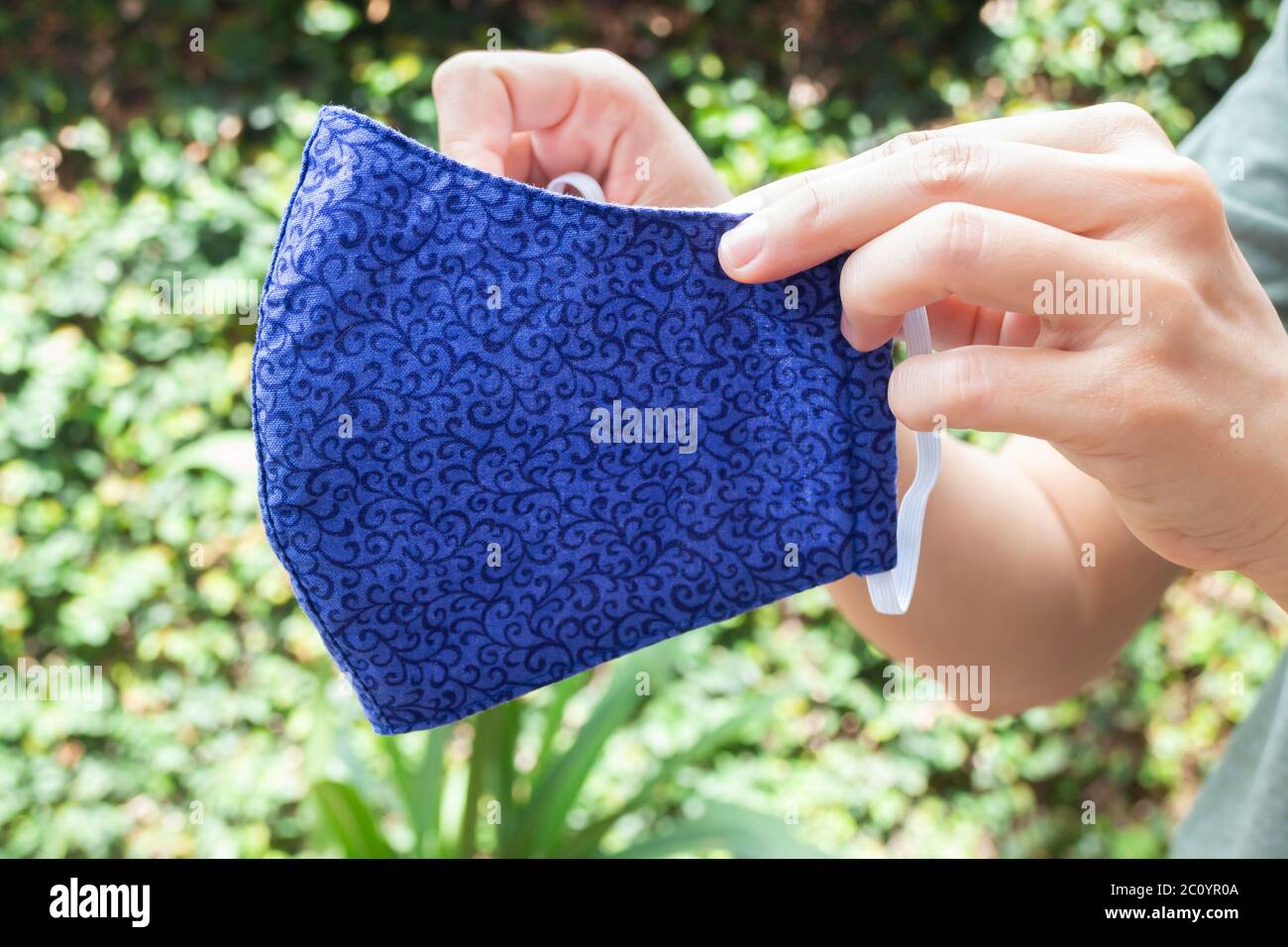 Woman shows self-made mask to protect against viruses and bacteria ...