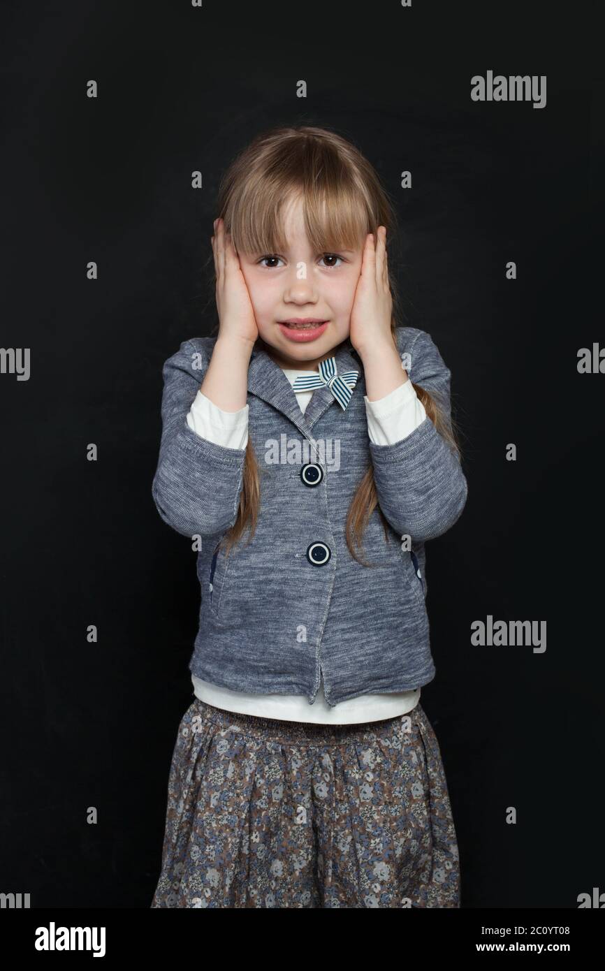 Sad unhappy child on black background portrait Stock Photo - Alamy