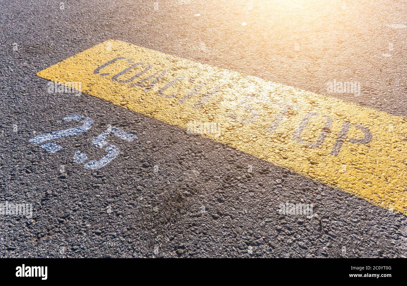 sign with coach stop on asphalt road in ligh Stock Photo - Alamy