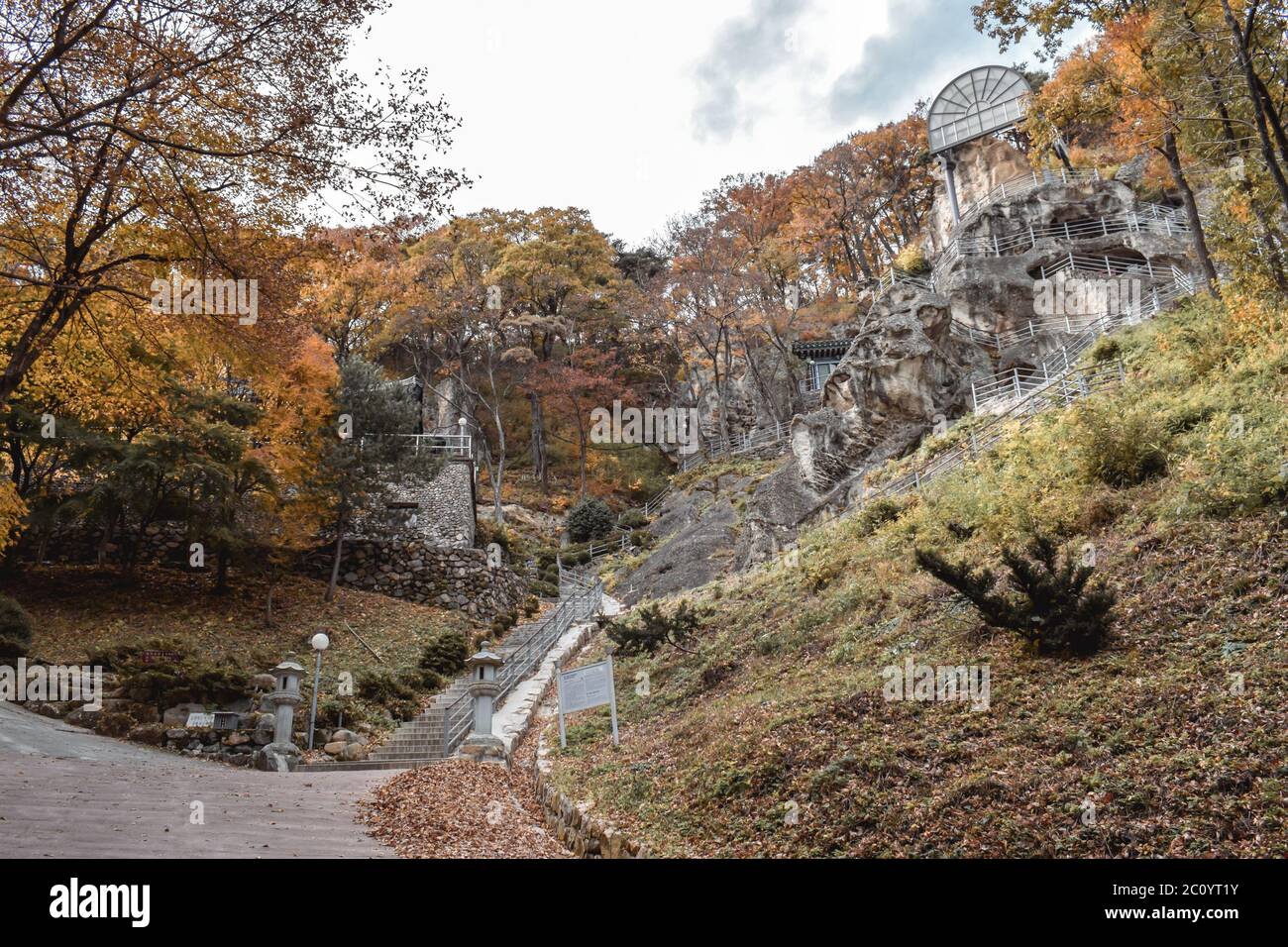 Stone stairs leading to a shrine with Big Buddha carved into a rock in ...