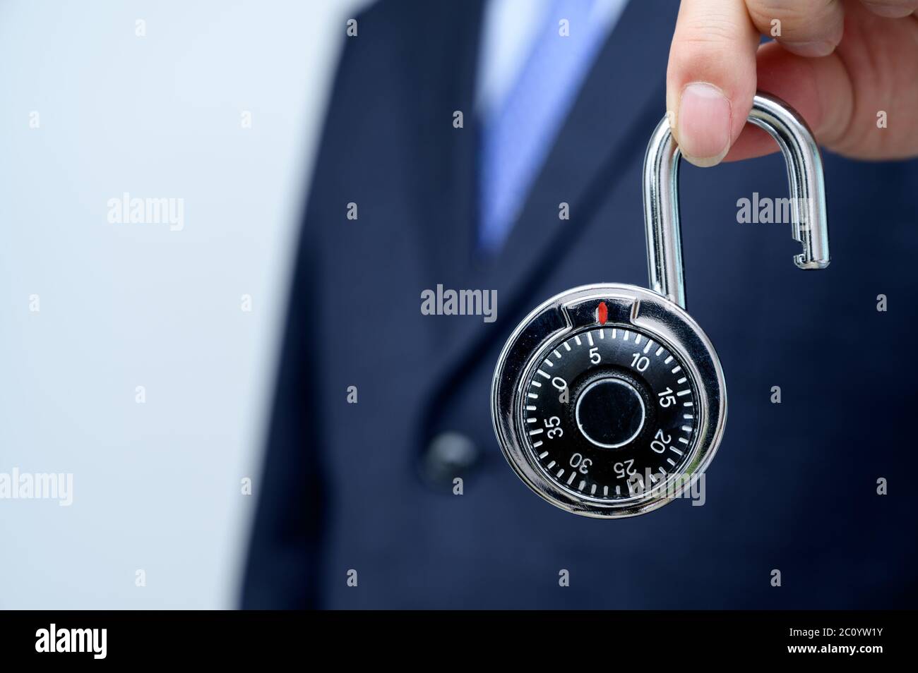 Businessman holding a lock. Business security concept Stock Photo - Alamy