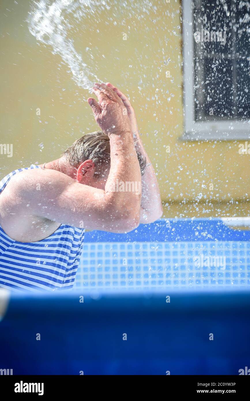Man with splashes of water in the pool Stock Photo - Alamy