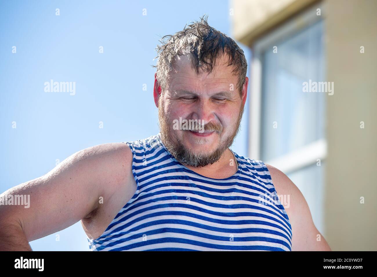 Summer heat. A young man, wet Stock Photo - Alamy