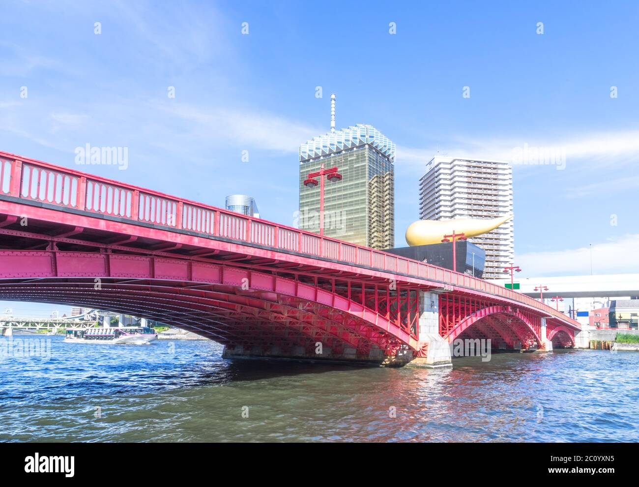 red bridge over water to modern buildings with blue skyline in tokyo ...