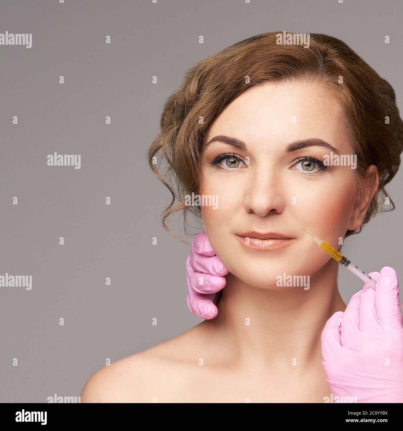 Face needle injection. Young woman cosmetology procedure. Doctor gloves ...