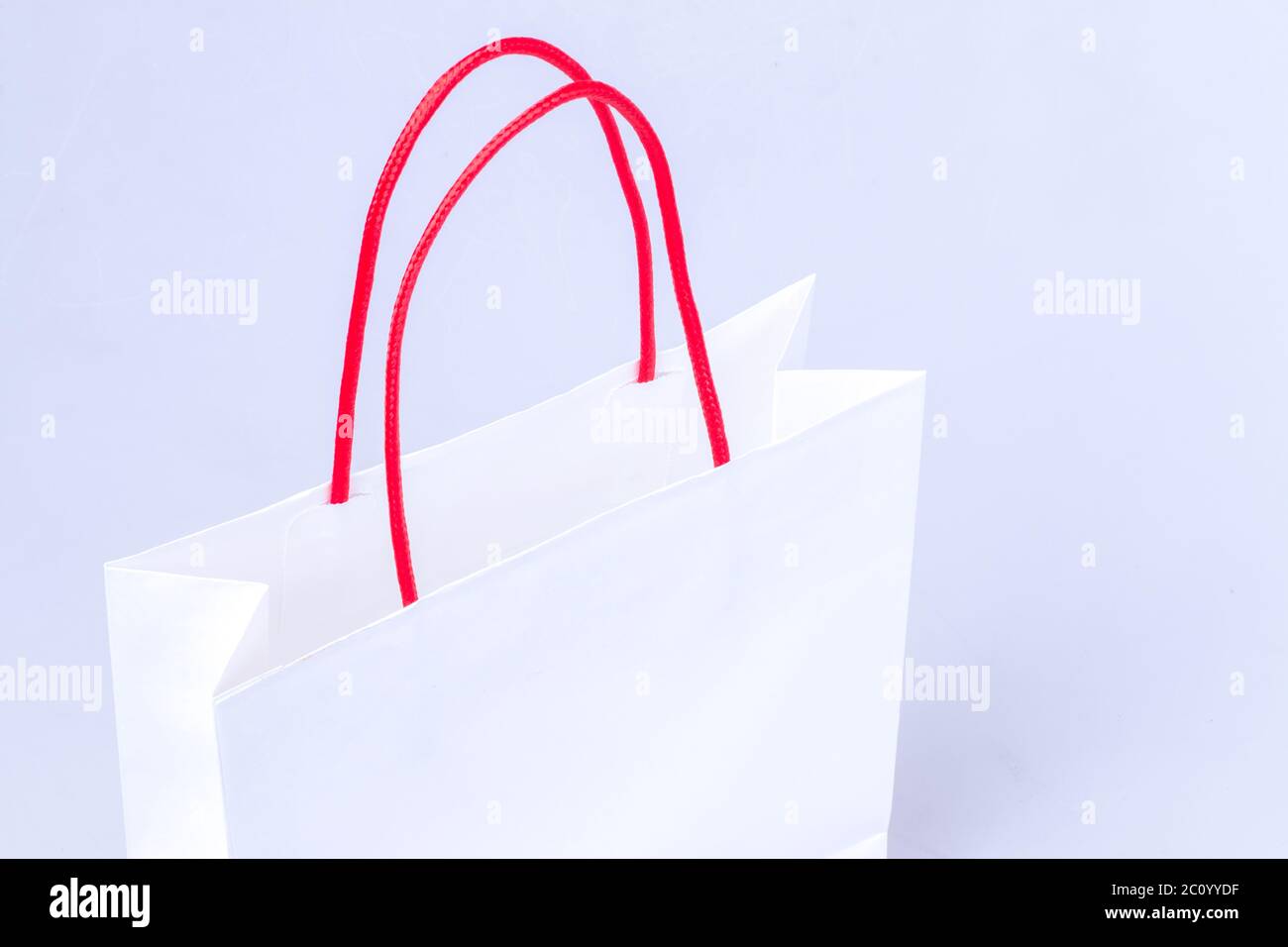 shopping paper bag with red handle Stock Photo - Alamy