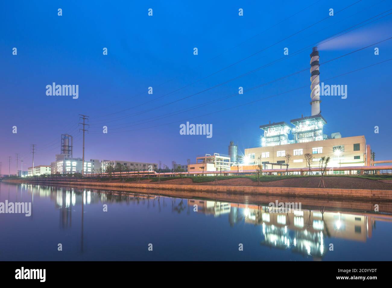 modern factory near river in blue sky at dawn Stock Photo - Alamy