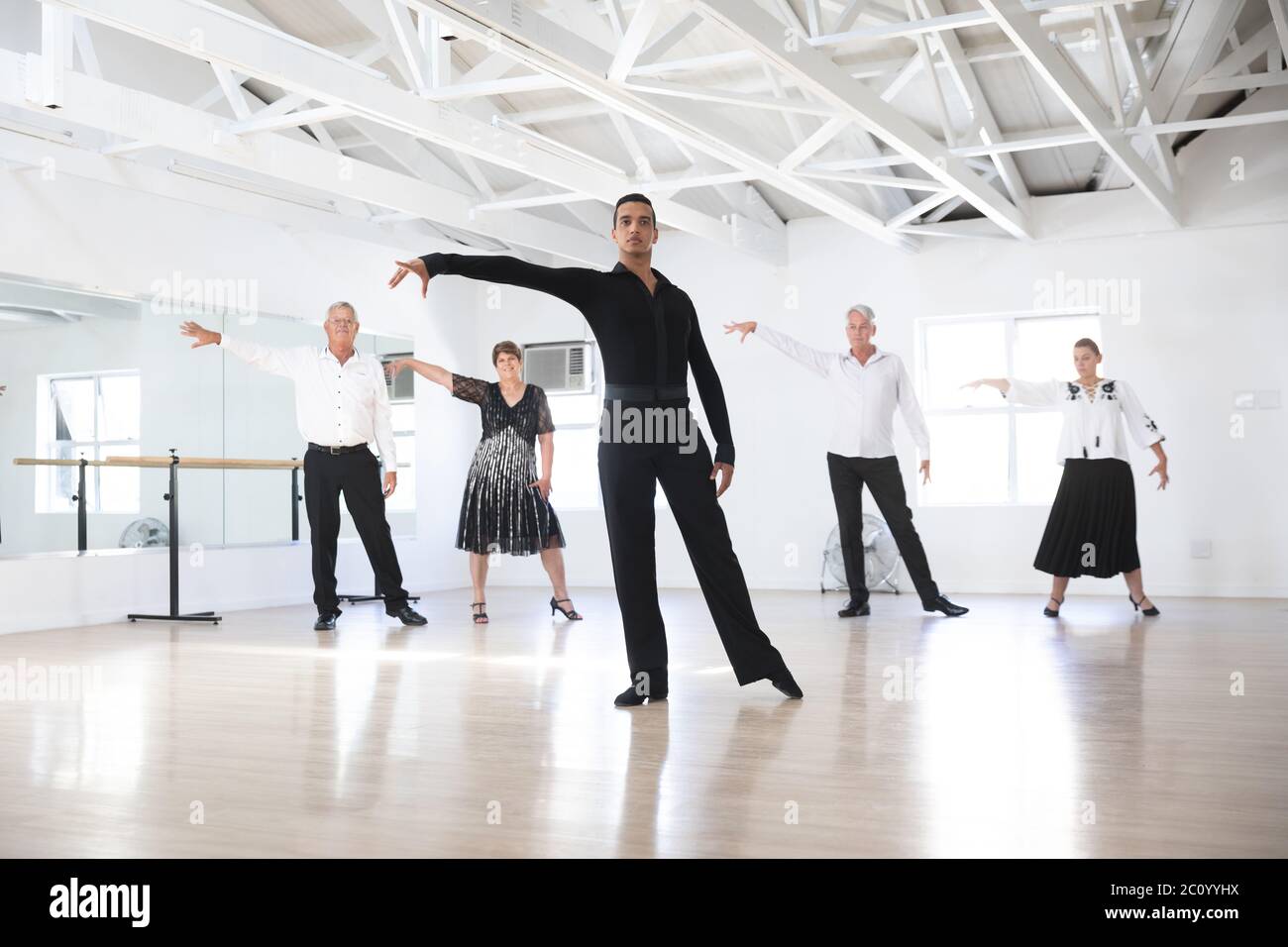 Mixed race dance teacher during ballroom dancing class Stock Photo - Alamy