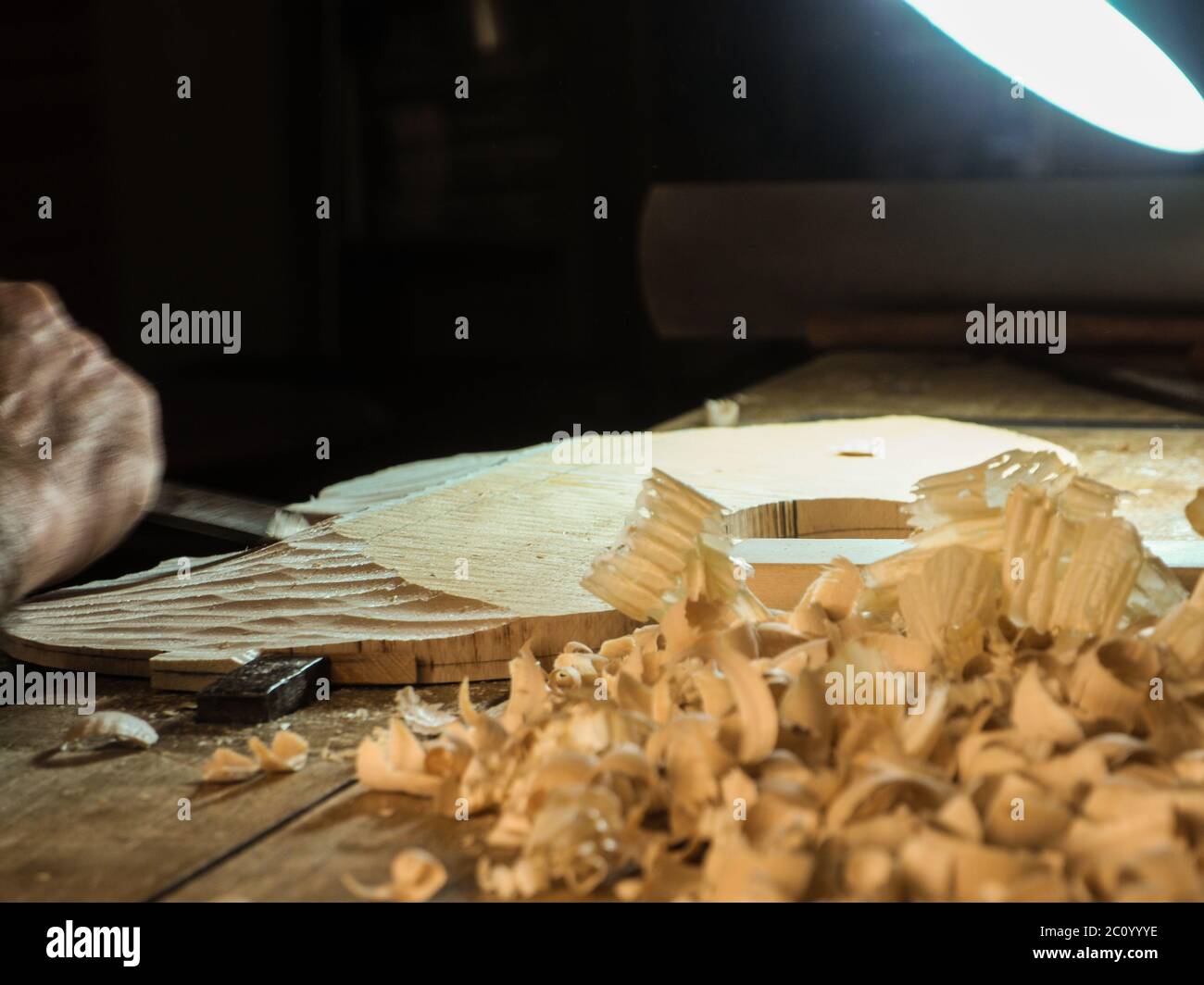 Professional luthier violinmaker artisan working on making a handmade ...