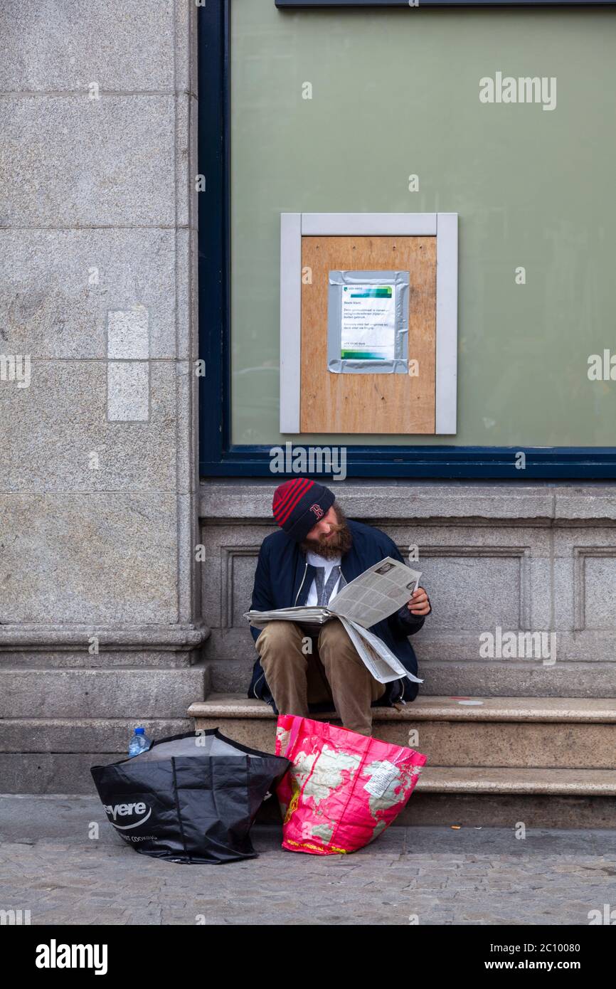 A homeless reading a newspaper,Amsterdam,Netherlands Stock Photo - Alamy