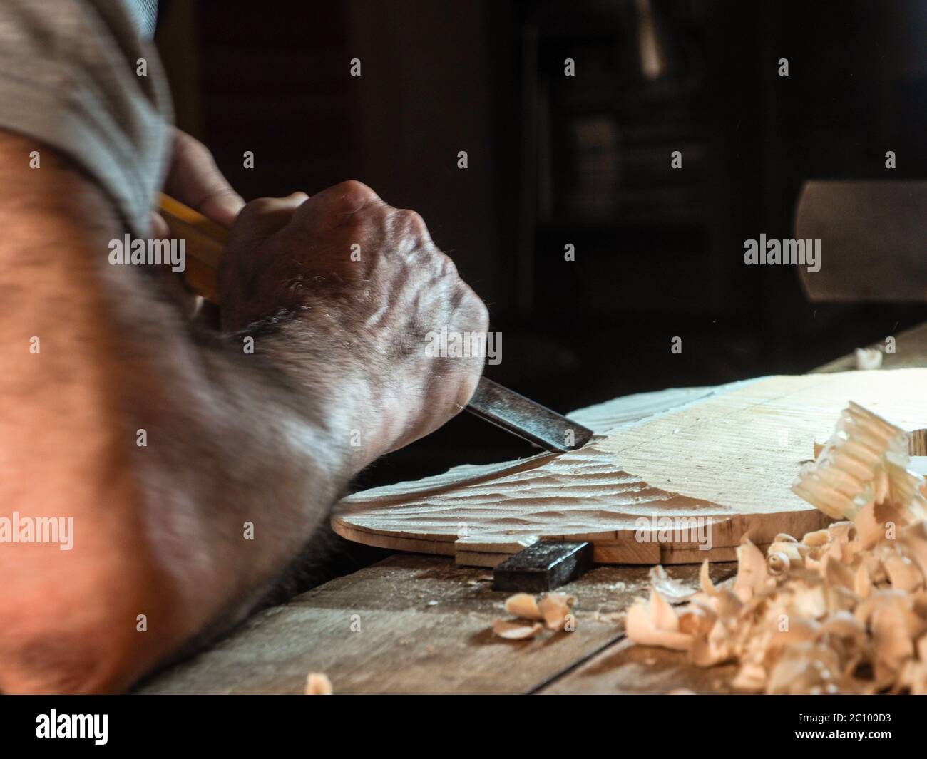 Professional luthier violinmaker artisan working on making a handmade ...