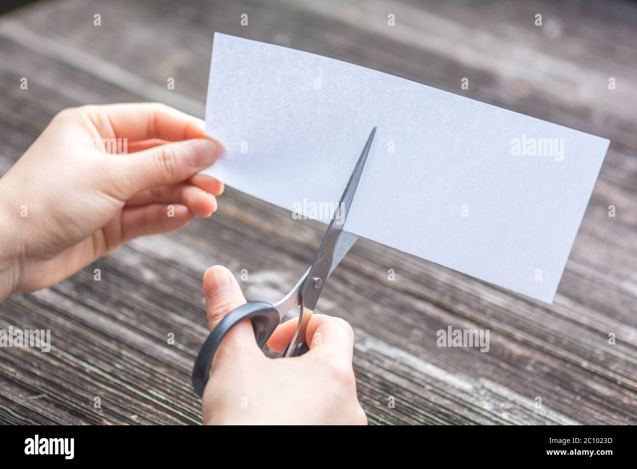 Hands cutting white paper hi-res stock photography and images - Alamy