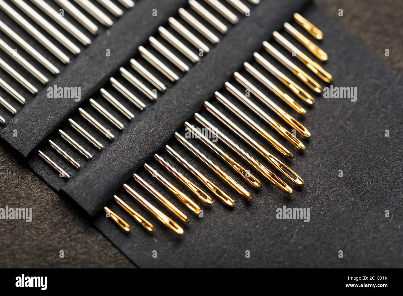 Set of Gold needles on a black background in a row Stock Photo - Alamy